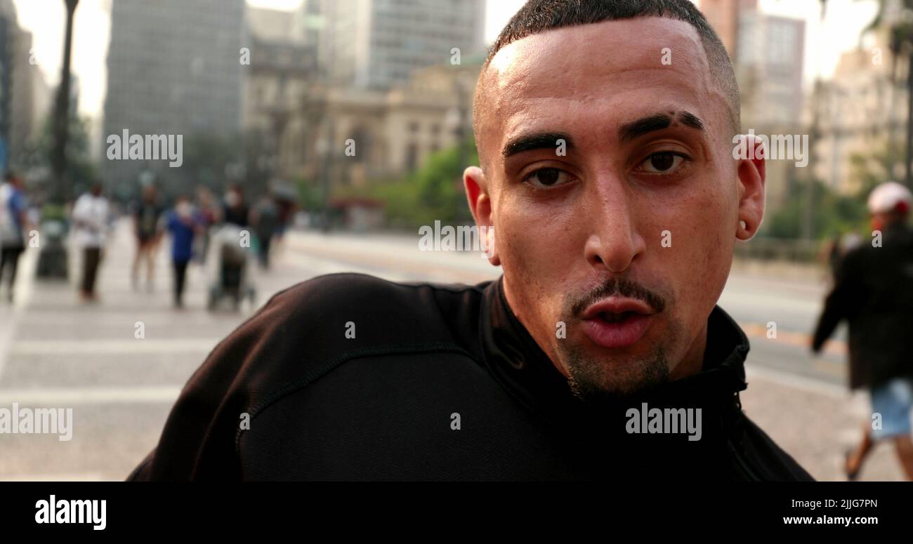 Urban dancer performing street dance with face only in city background ...