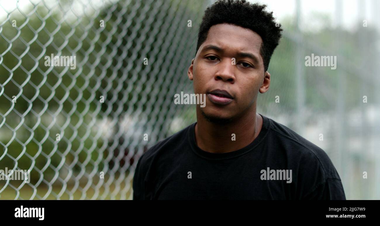 Young black guy outside walking. serious african man Stock Photo - Alamy