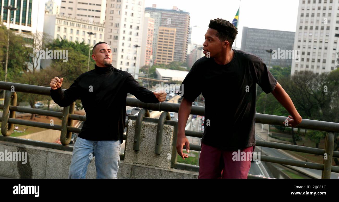 Young men dancing freestyle outside. Urban dancers performing in ...