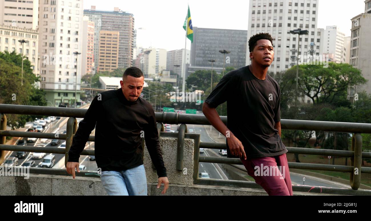 Young men dancing freestyle outside. Urban dancers performing in ...