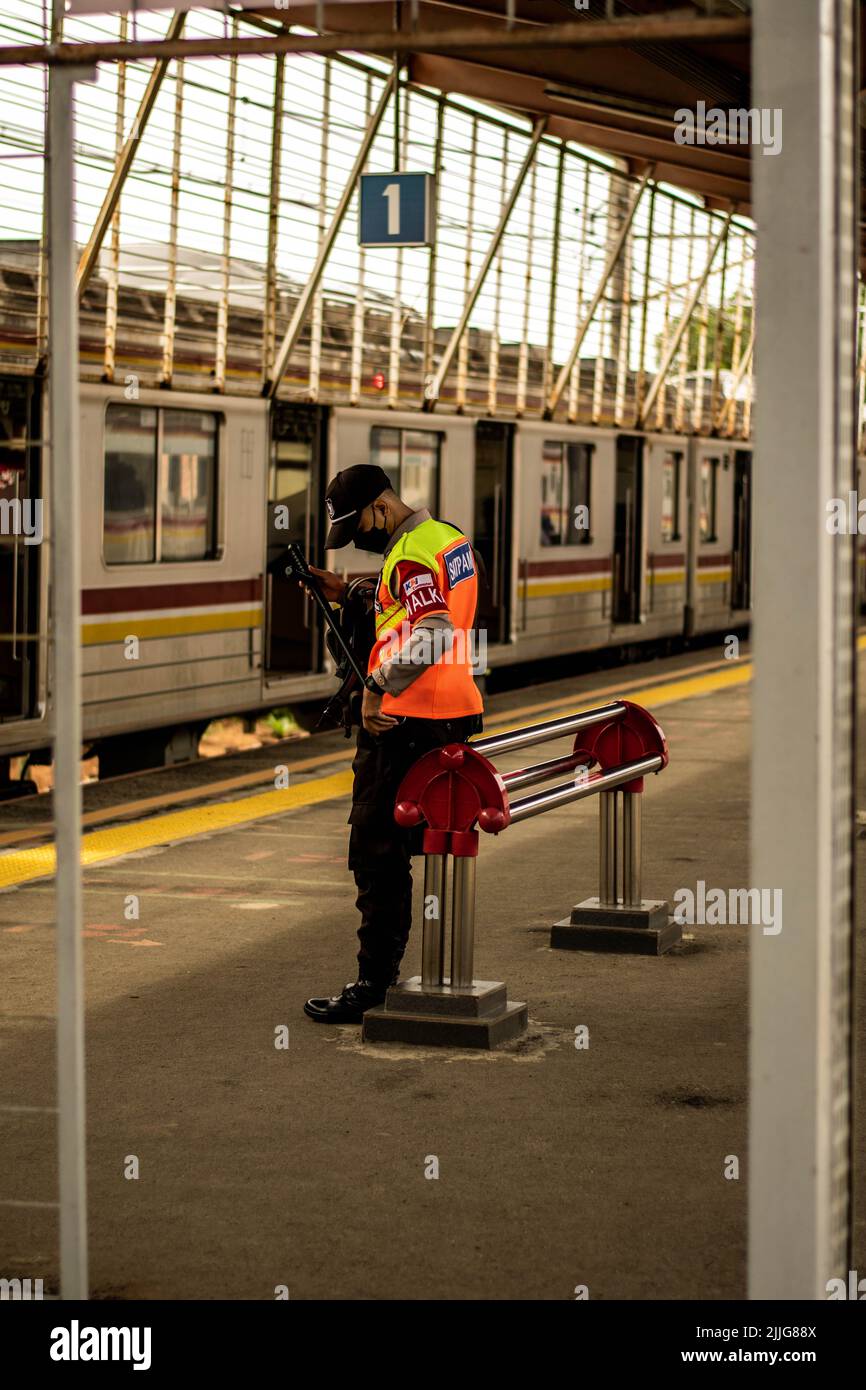 A vertical shot of a security guard on a Depok Railway Station, West ...