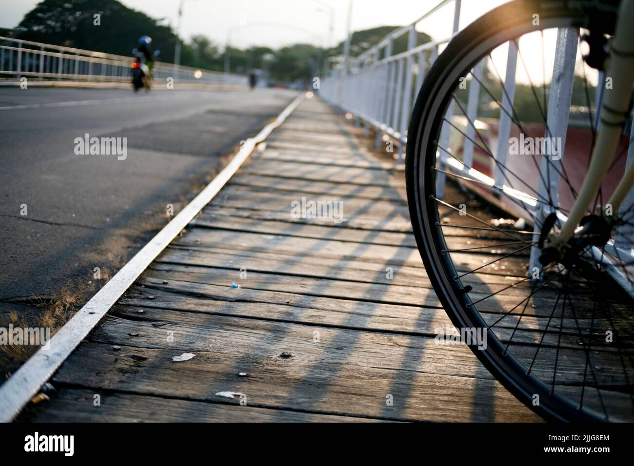 Front wheel of bicycle in wooden bridge Stock Photo - Alamy