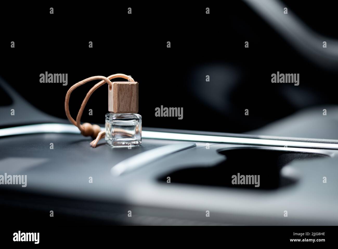 Car air perfume freshener bottle inside the car on car panel. Aromatic ...