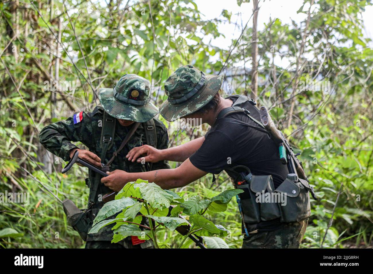 A Karenni Nationalities Defence Force (KNDF) soldier helps his co-soldier to install his rifle ...