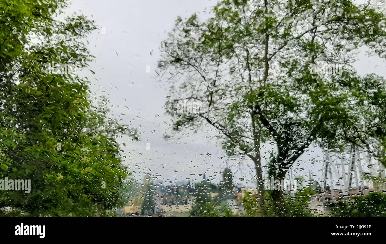 Raindrops on the window. Outside the window streetscape Stock Photo - Alamy