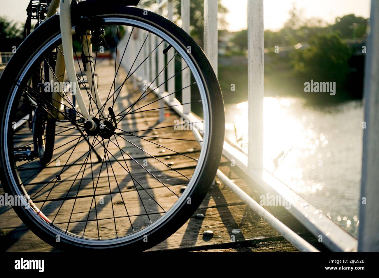 Front wheel of bicycle in wooden bridge Stock Photo - Alamy
