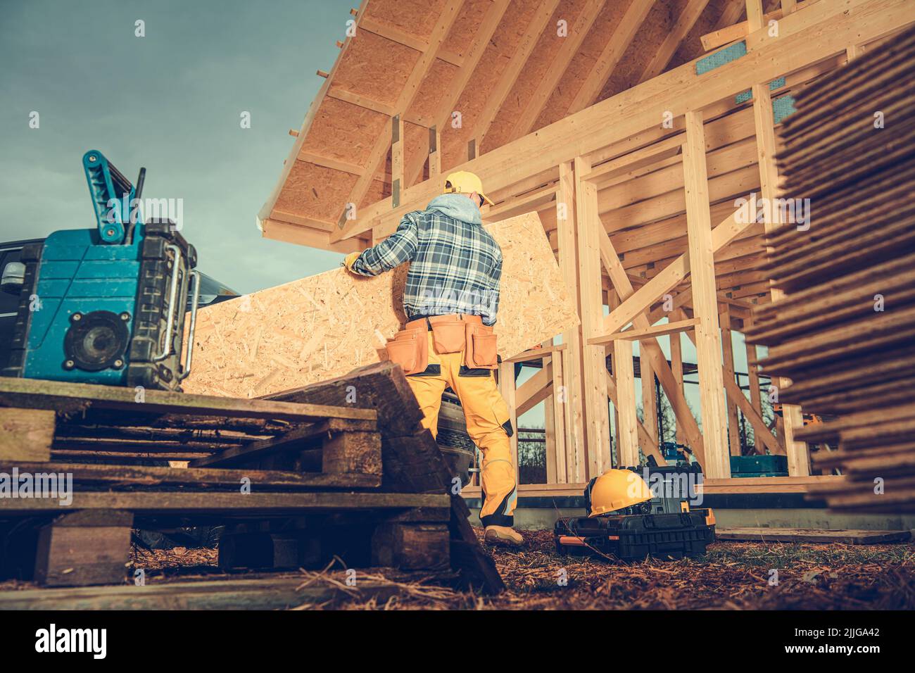 Male Worker Preparing to Start Work on the Wooden House Frame Building ...