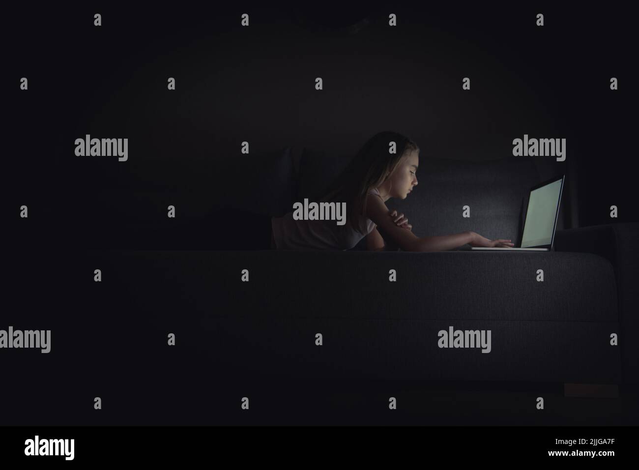 Caucasian Girl Lying on the Sofa in Front of a Switched-on Laptop ...