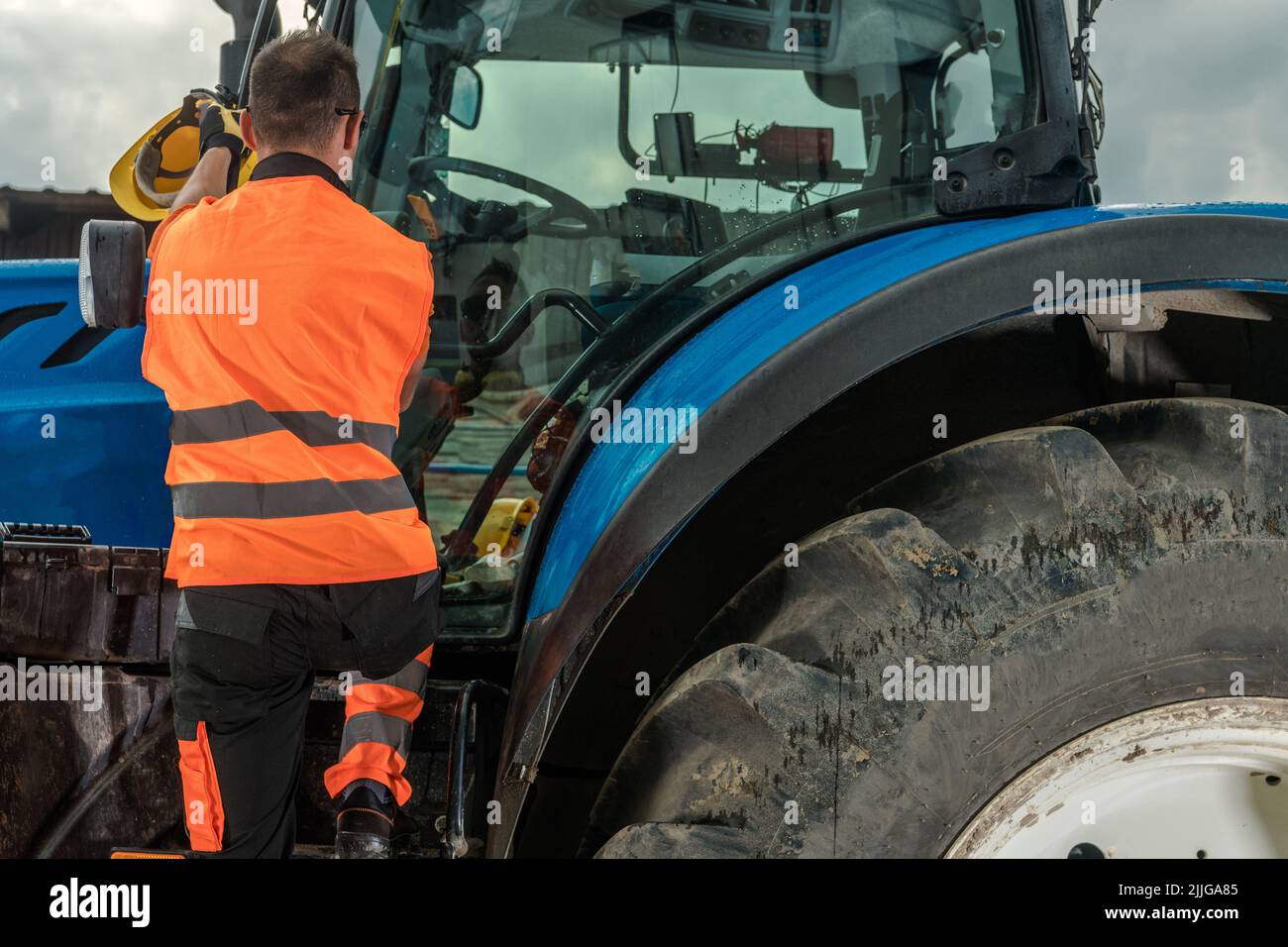 Rear View of Male Contractor Wearing Orange Fluorescent Work Wear ...