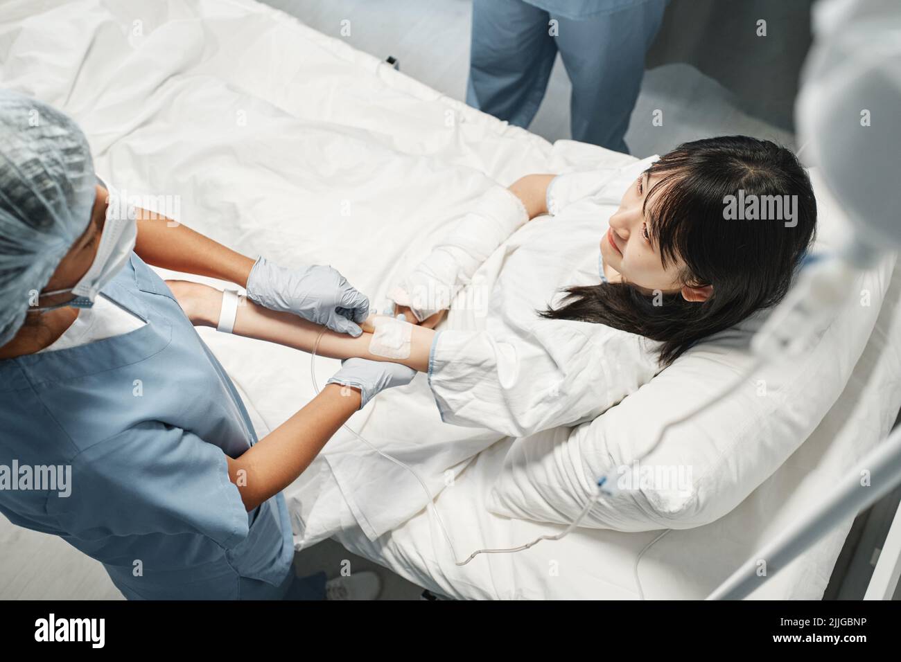Horizontal high angle view shot of young Asian woman getting ...