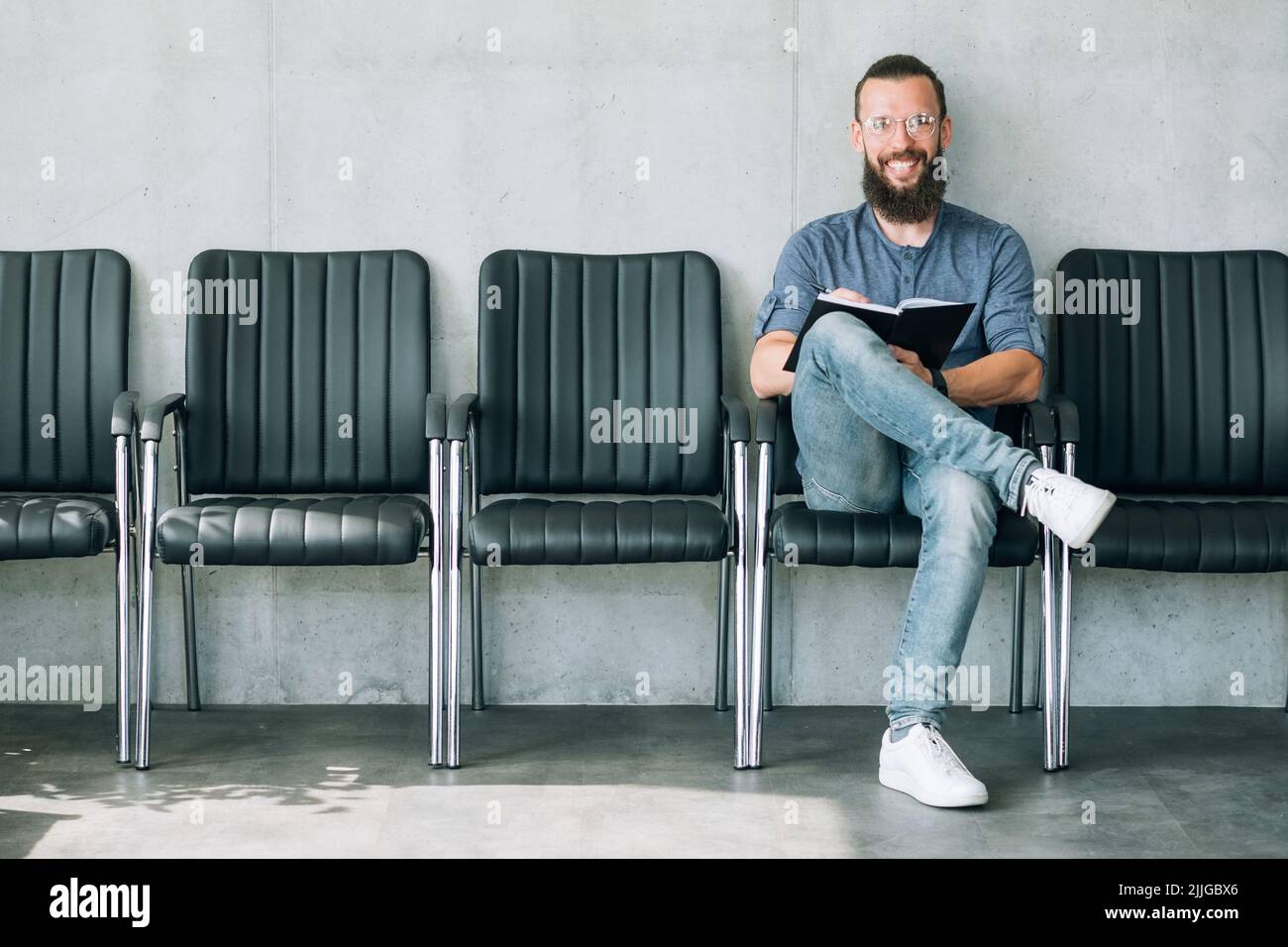 man sit row empty chairs interview job hiring Stock Photo - Alamy
