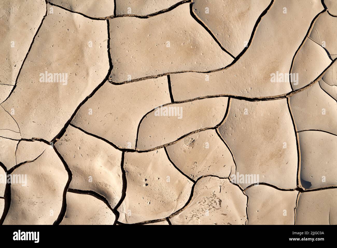 Abstract pattern of dry cracked clay mud in dried up river bed caused ...