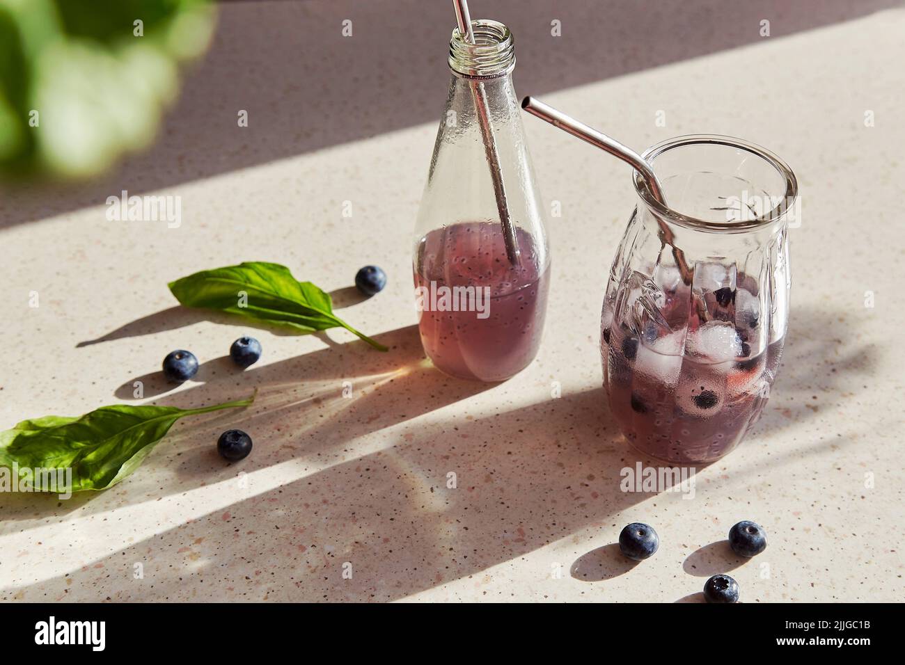 Natural herbal organic drink with blueberries, basil extract, ice under ...