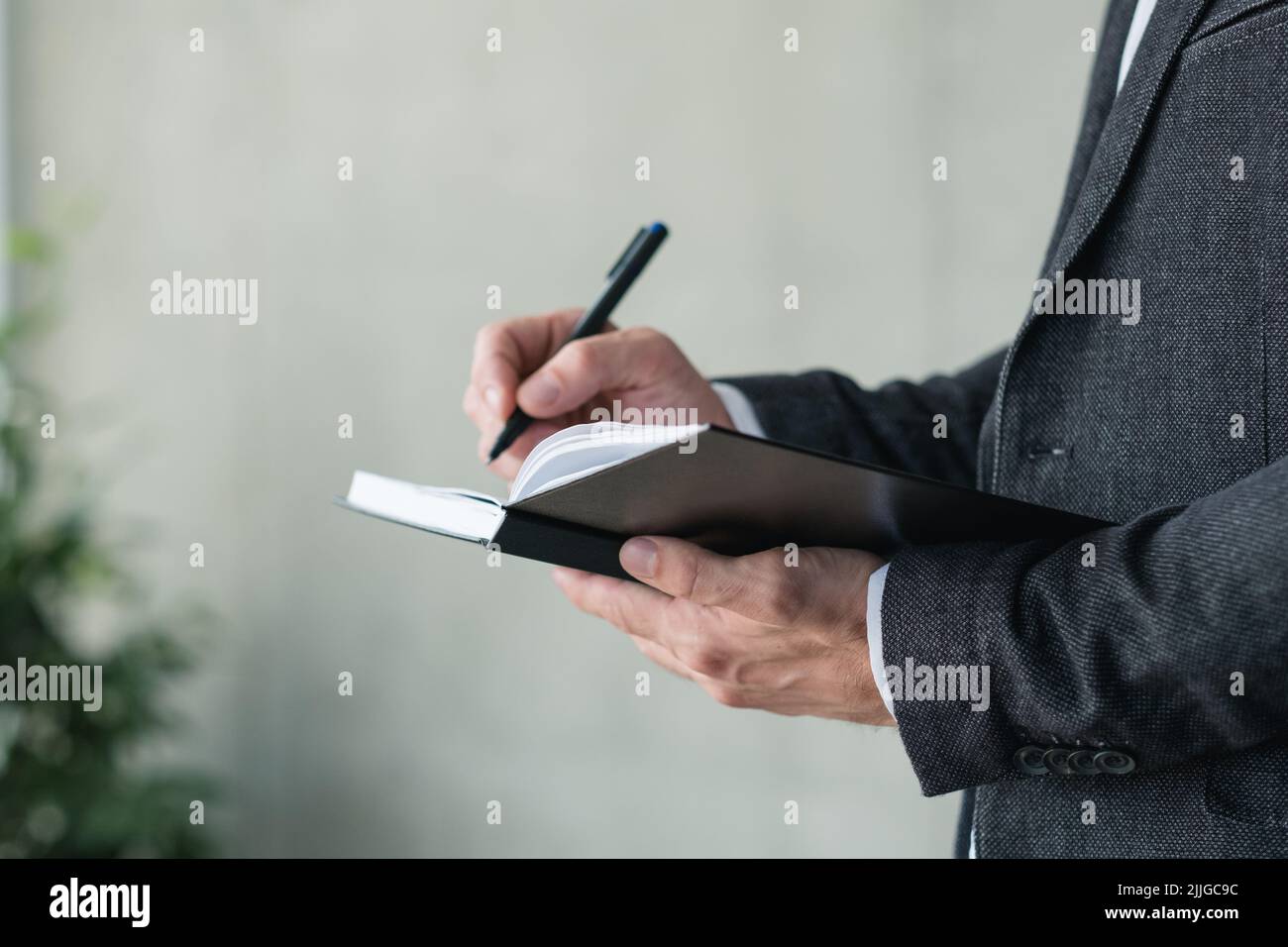 man hand writing notebook business planning agenda Stock Photo - Alamy