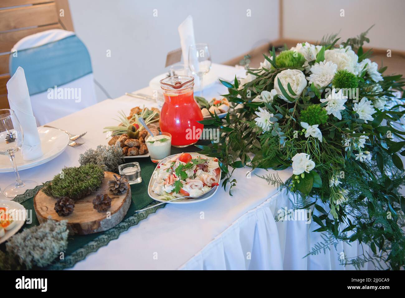 A high angle shot of juice and appetizers on a wedding venue table ...