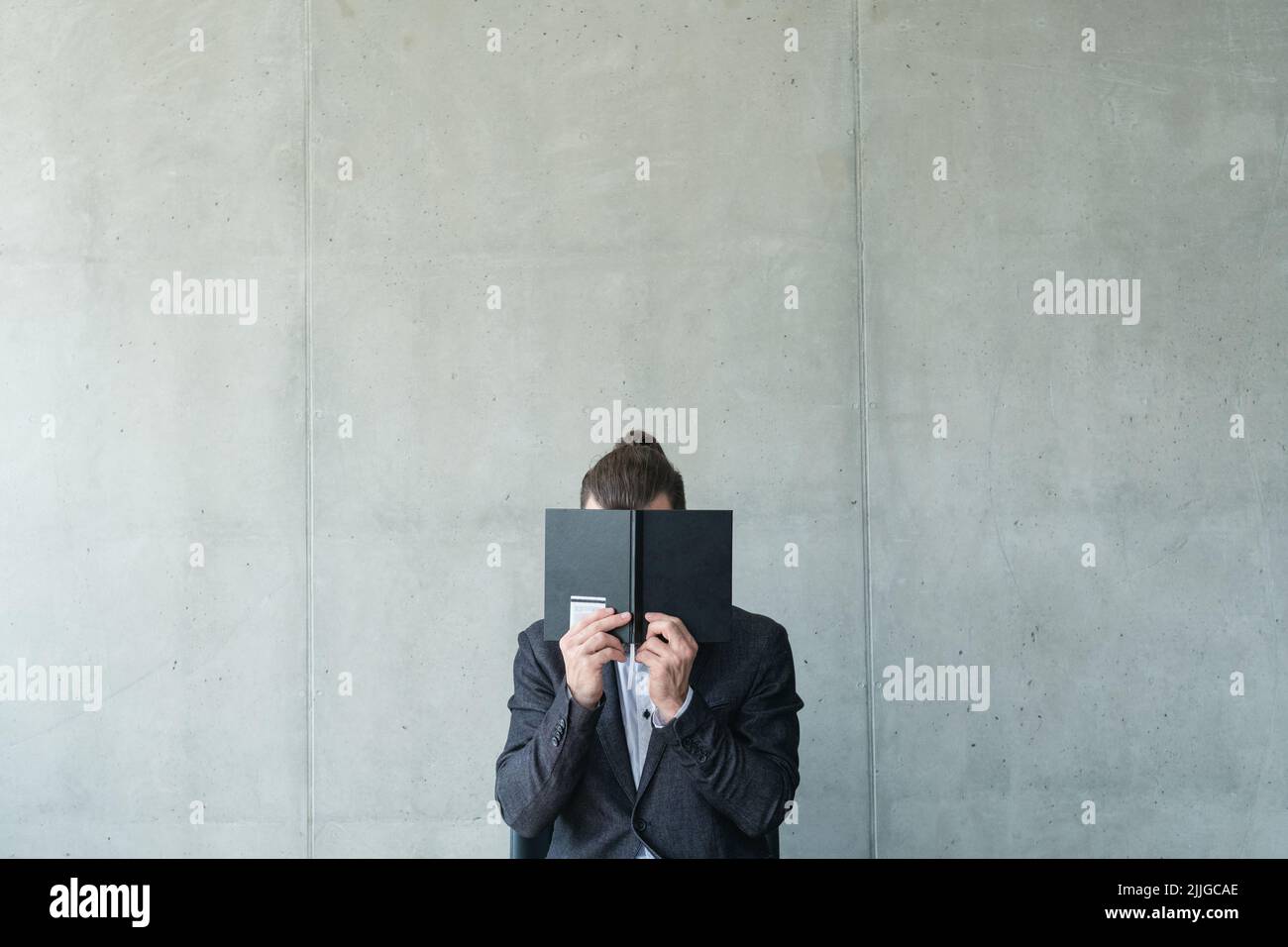 business man cover face notebook bookworm reading Stock Photo - Alamy