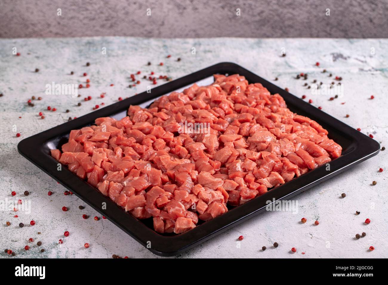 Cubed meat. Chopped red meat on stone background. Butcher products ...
