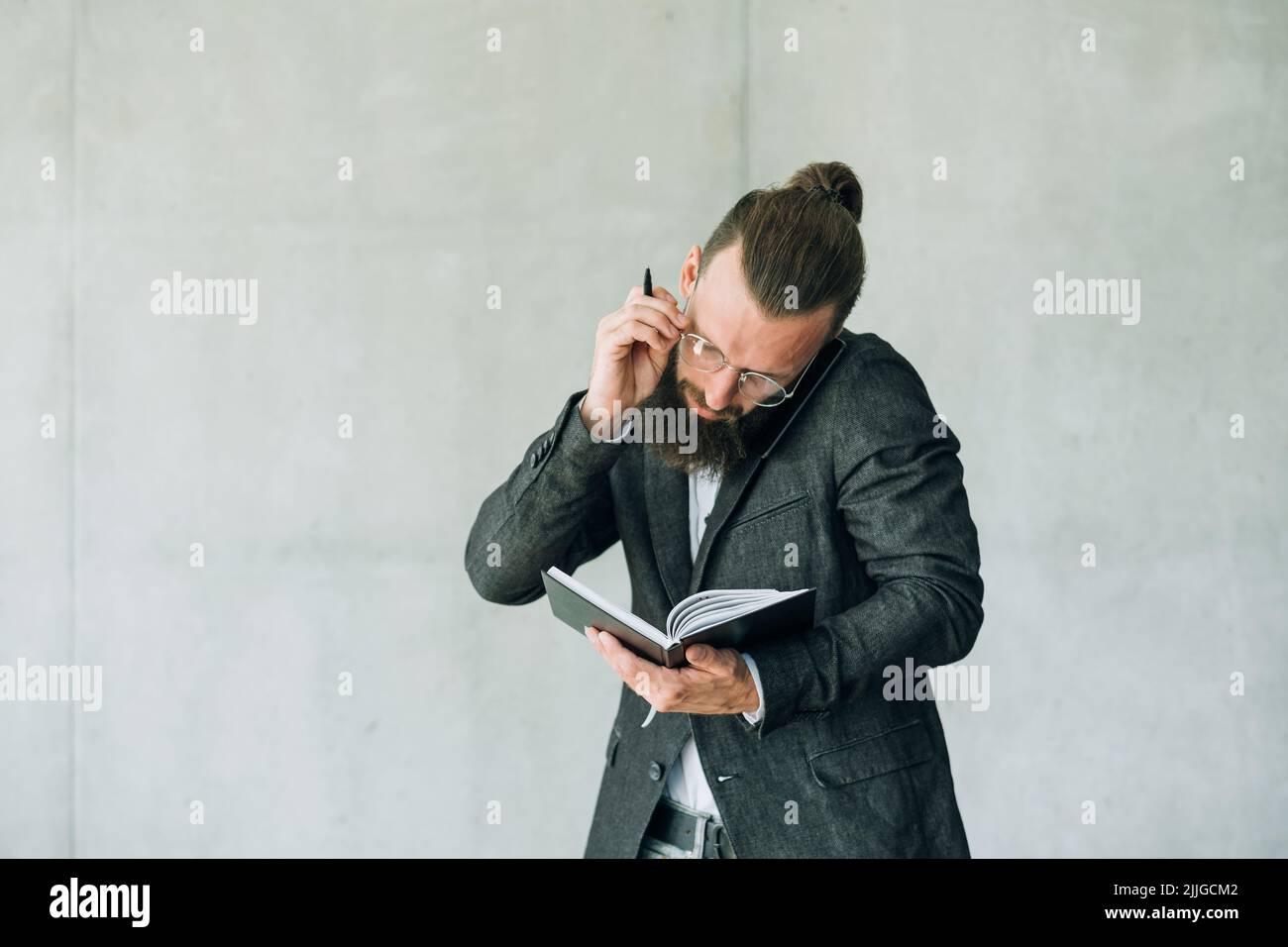 busy business man check day planner talk phone Stock Photo - Alamy