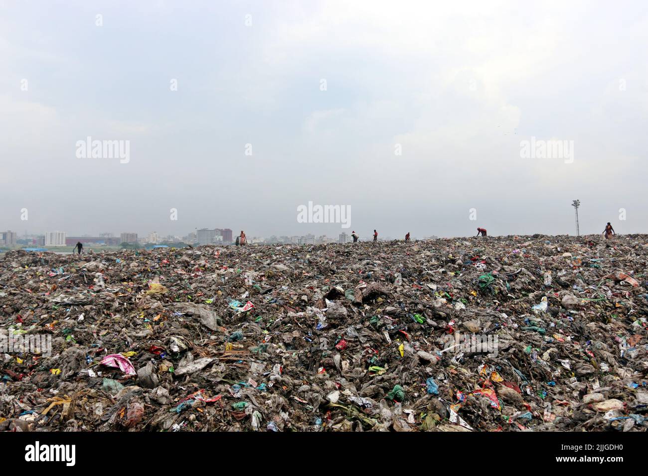 People recycle non-biodegradable waste at a garbage dump in Dhaka to be ...