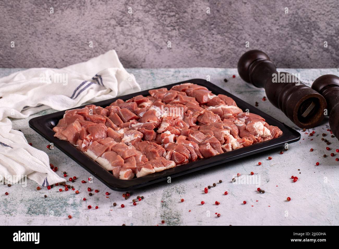 Lamb cubed meat. Chopped red meat in a wooden serving dish on a stone ...