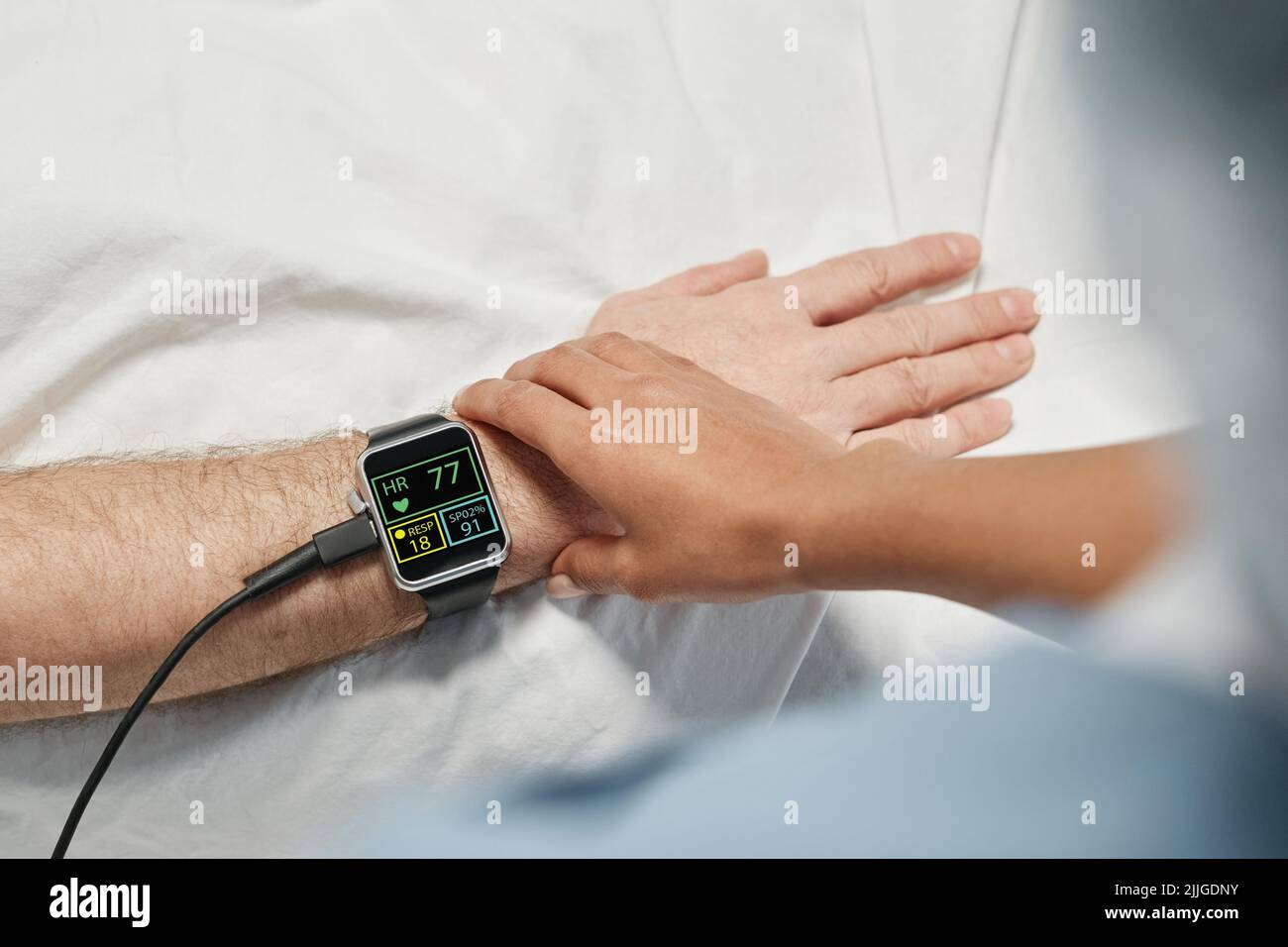From above shot of unrecognizable doctor checking heart rate of male ...