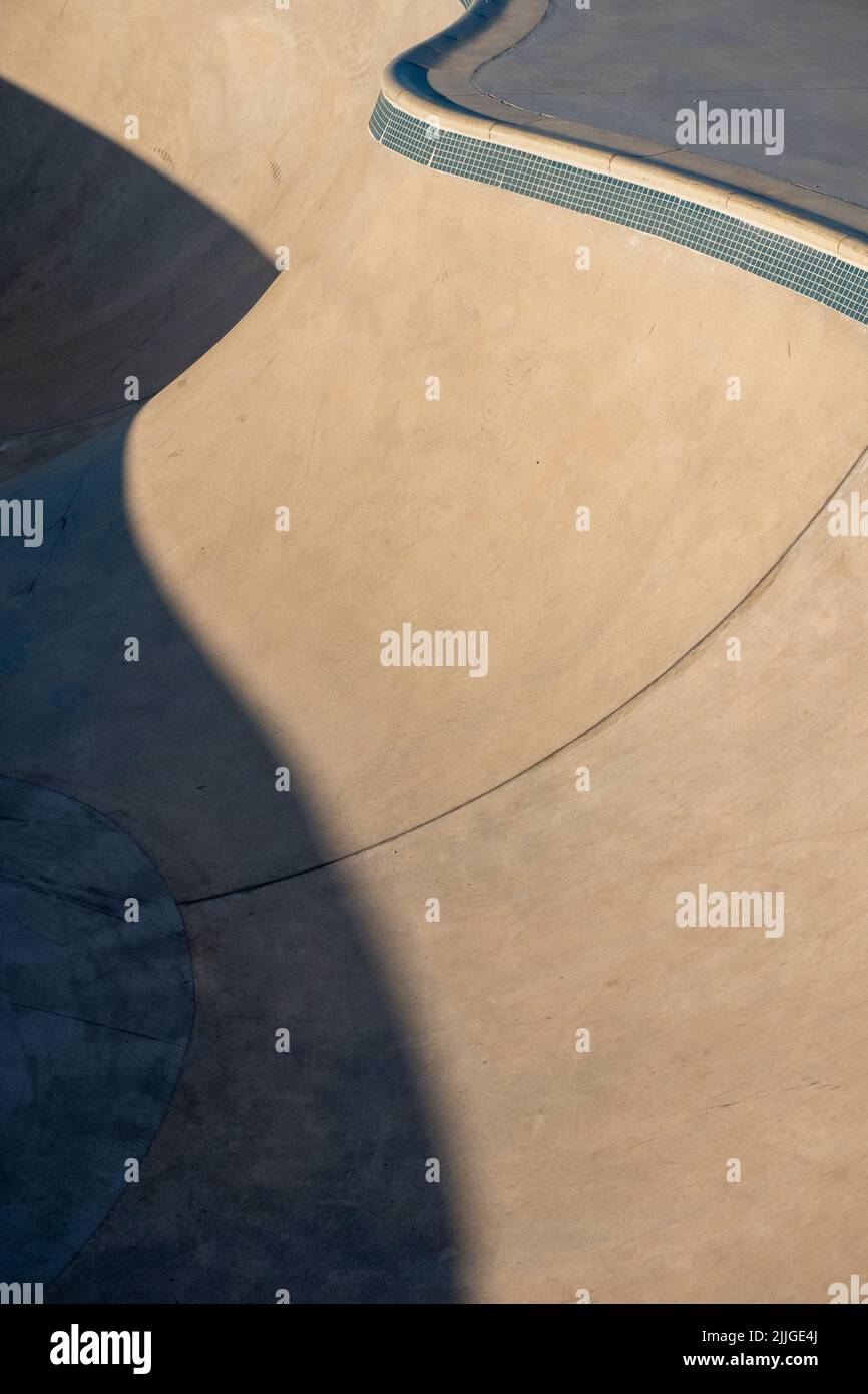 transitions of a skatepark bowl at sunrise, pool skateboard concept ...