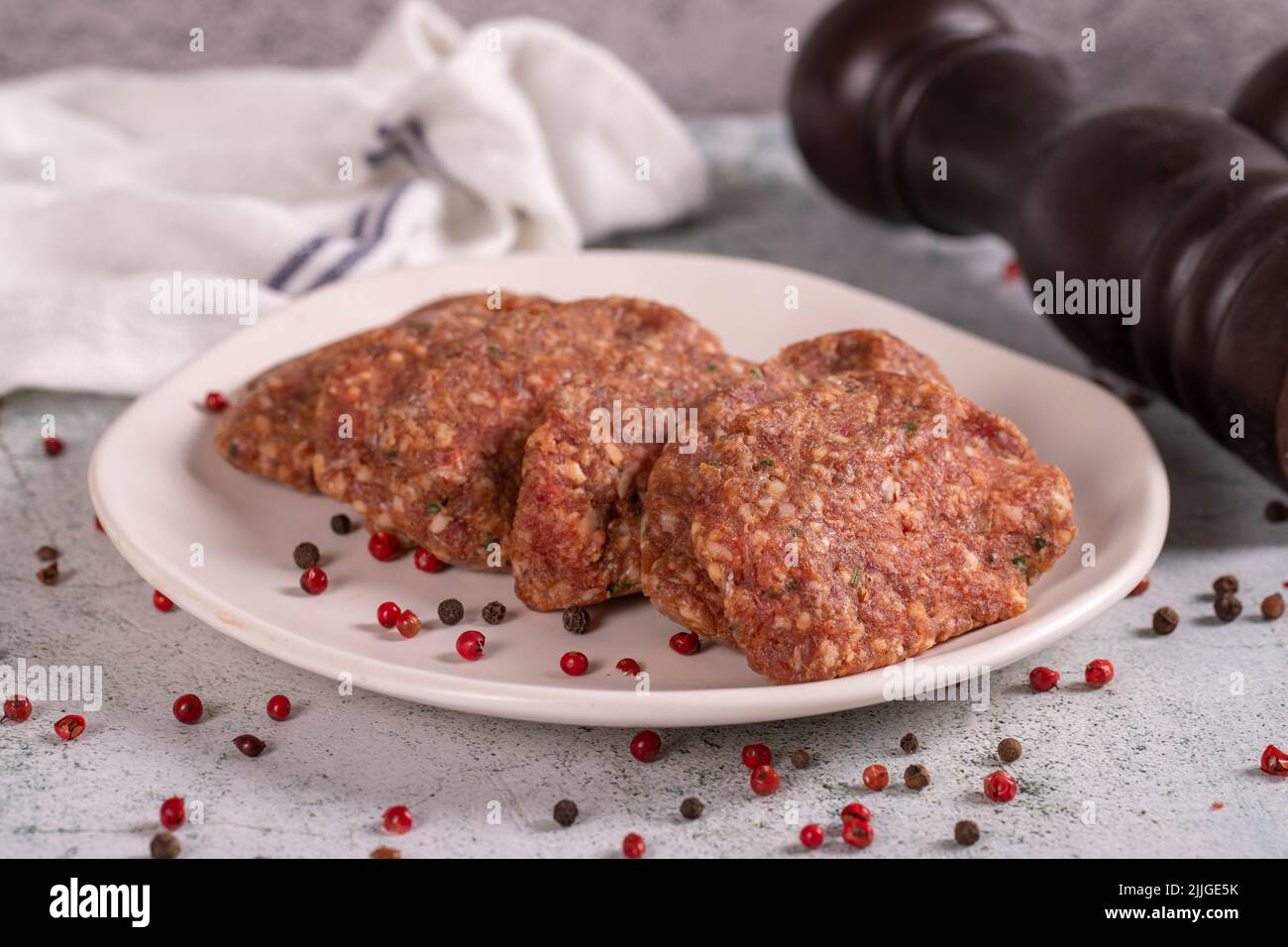 Uncooked spicy grilled meatballs. Meatballs in a plate on a stone ...