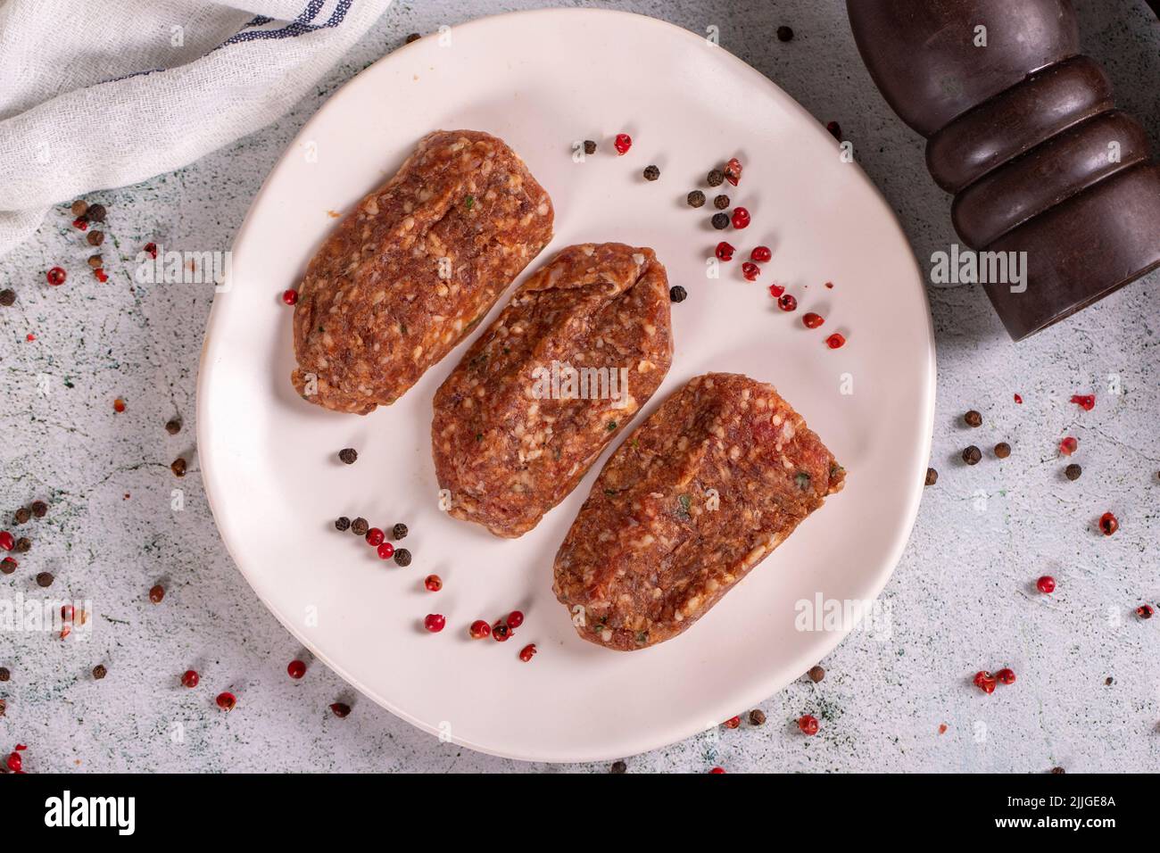Uncooked spicy grilled meatballs. Meatballs in a plate on a stone ...