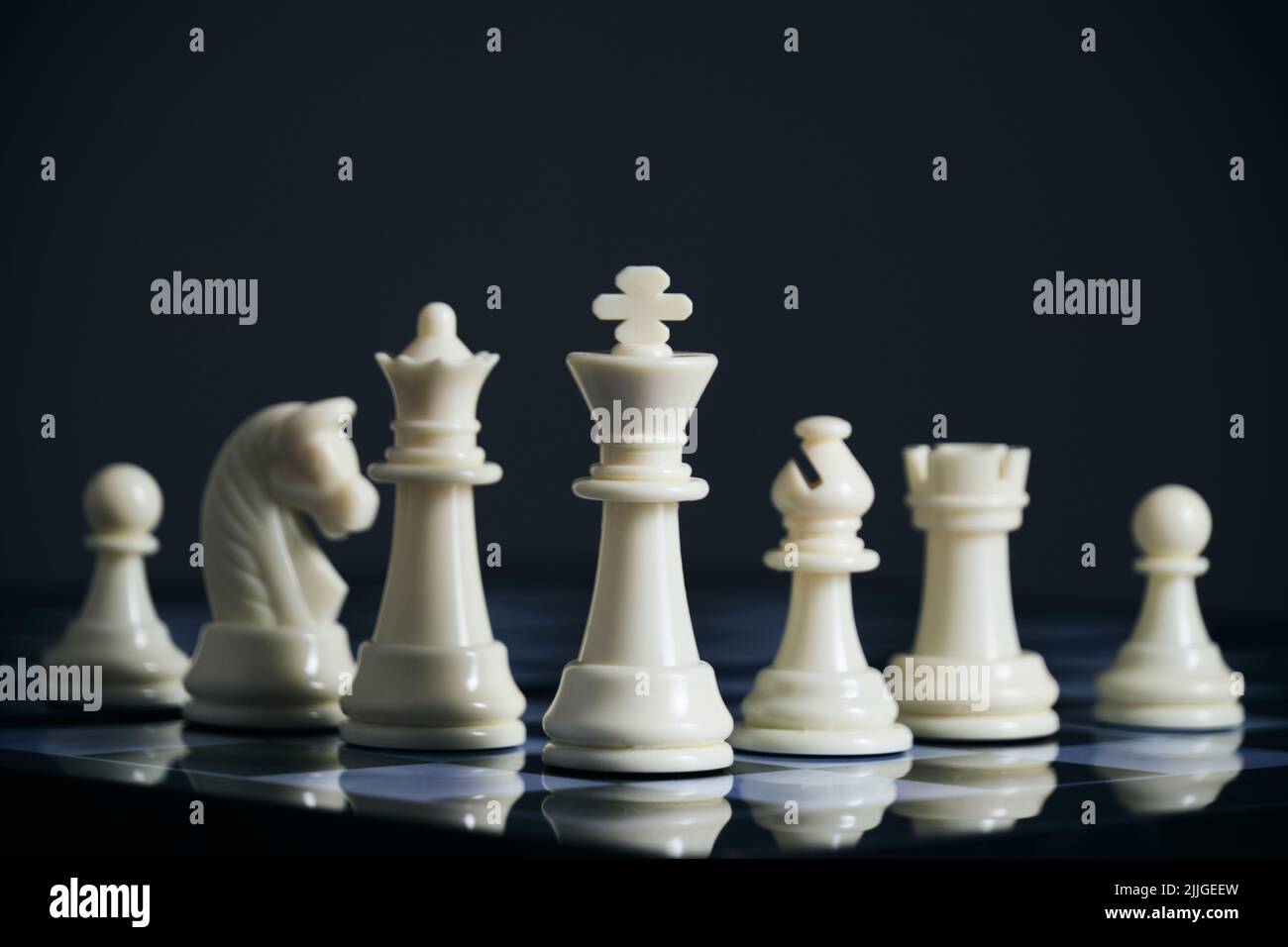 All suits white chess pieces on chess board Stock Photo - Alamy