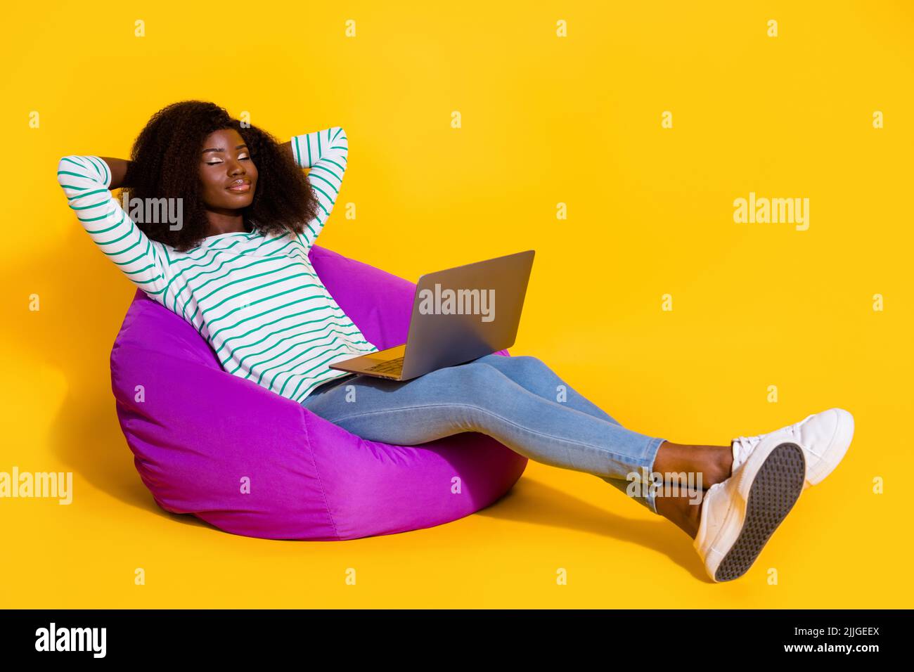 Full size photo of peaceful charming girl sit bag hands behind head ...