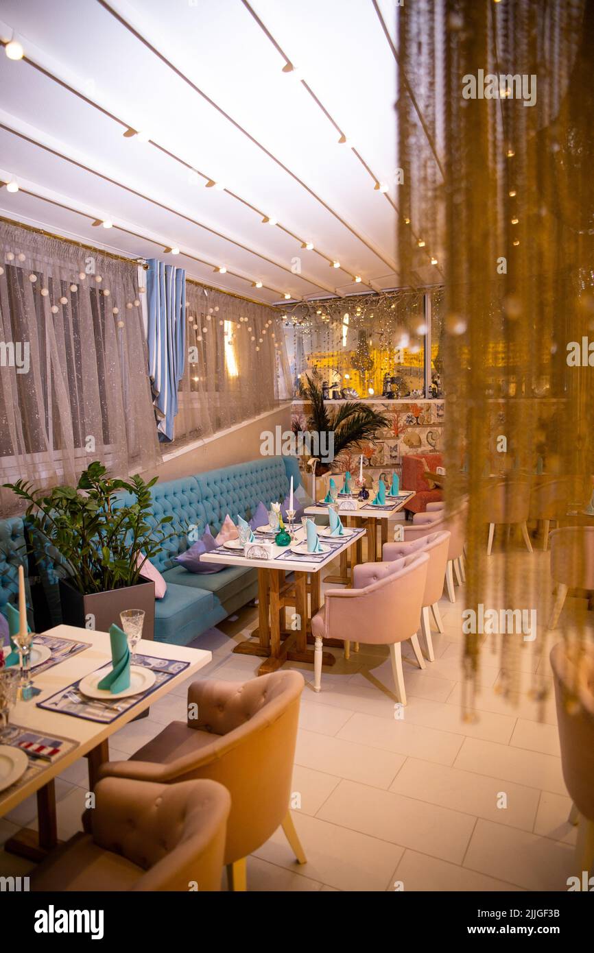 tables and chairs in the interior of an atmospheric restaurant Stock ...