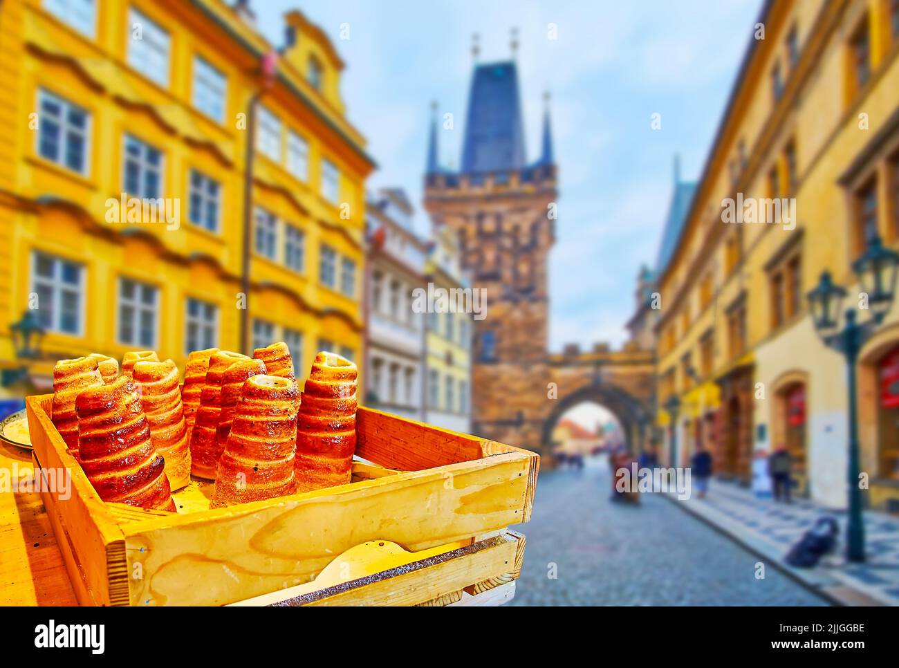 The tray with fresh trdelnik Bohemian pastry in front of Mala Strana ...