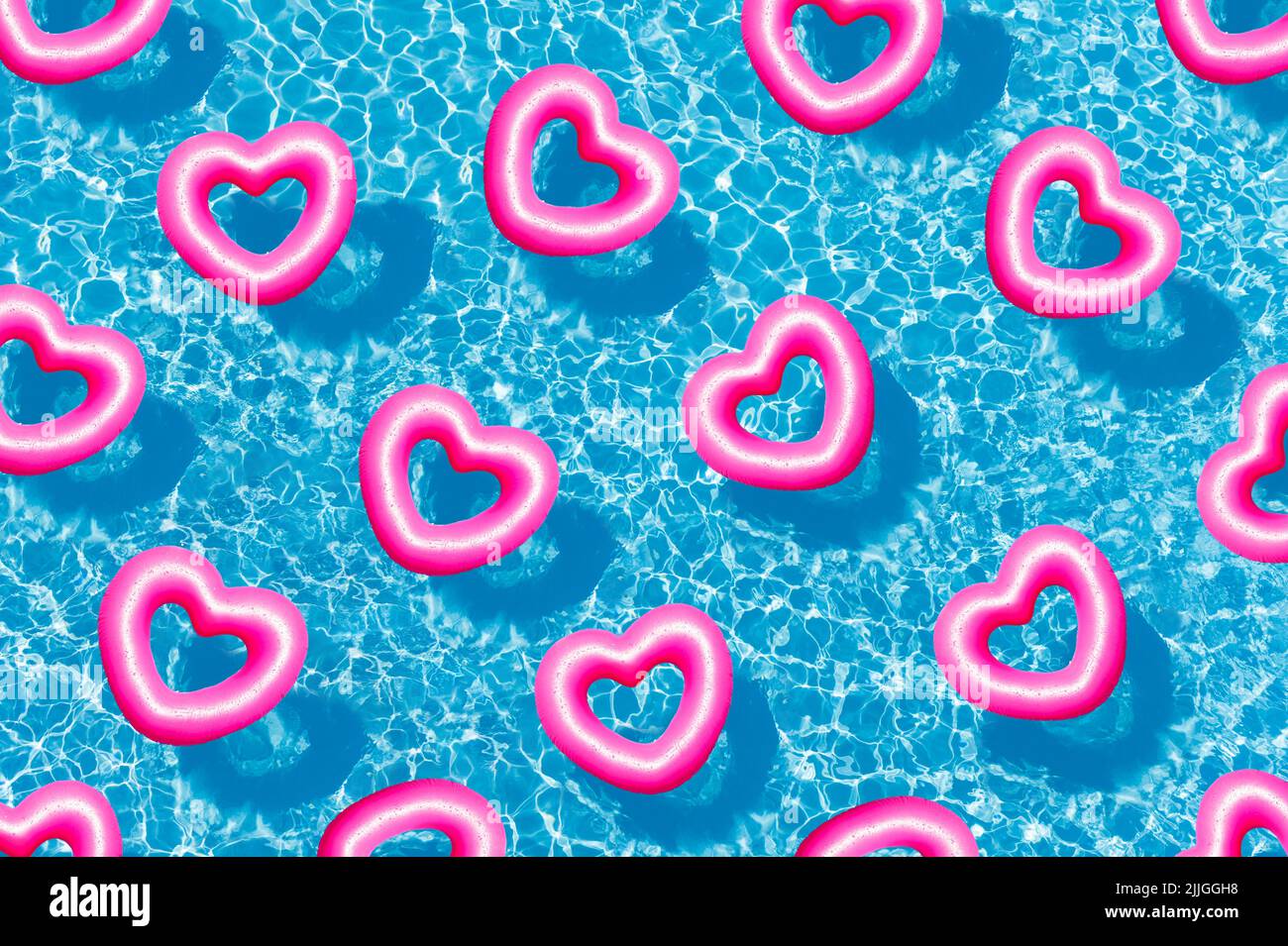 Pool with many pink buoys floating of heart shape from above Stock ...