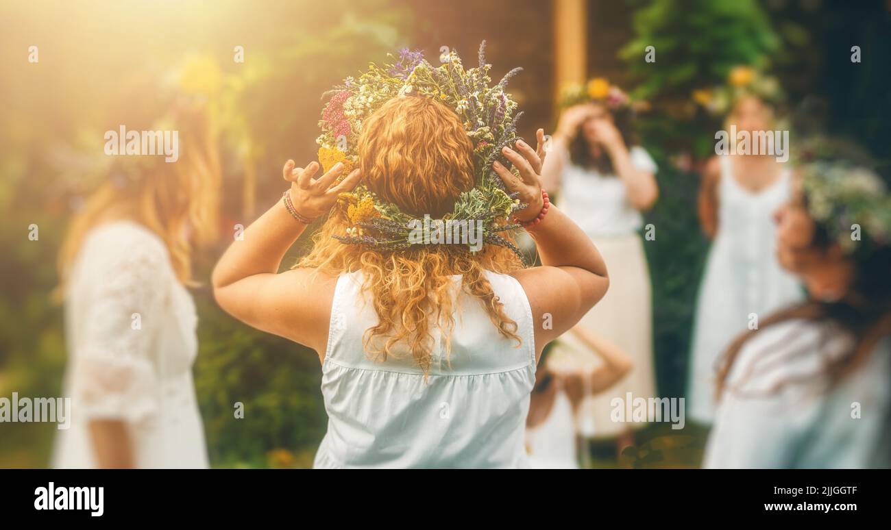 Women in flower wreath on sunny meadow, Floral crown, symbol of summer ...