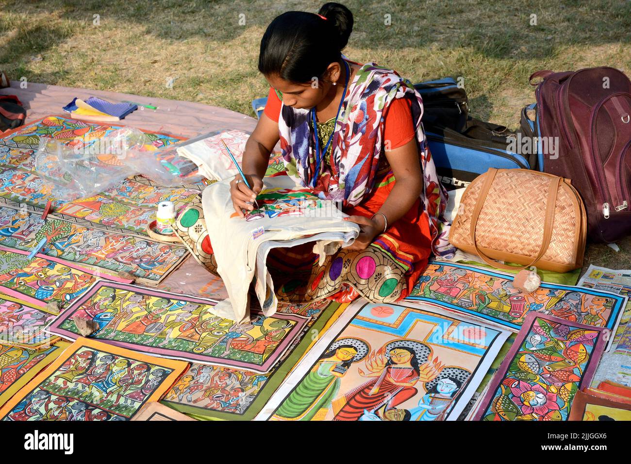 The Bengali women were making hand painting on the selling handicraft ...
