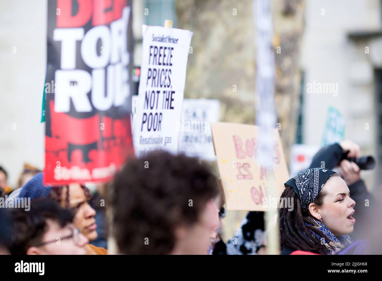 Placards are held as participants gather during a Cost of Living Crisis ...