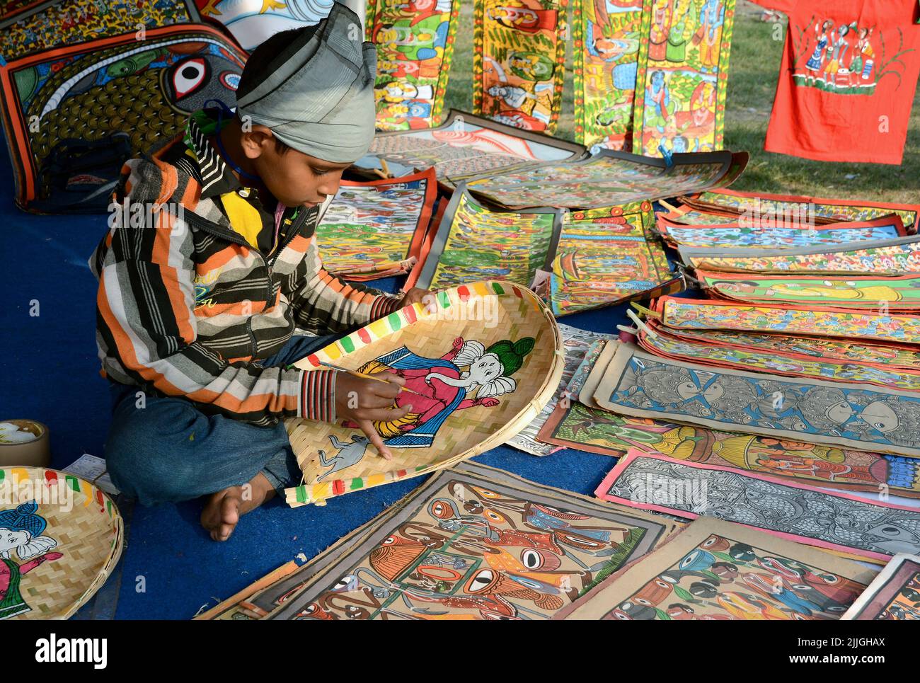 The little boy drawing hand painting on the hand craft product as well ...
