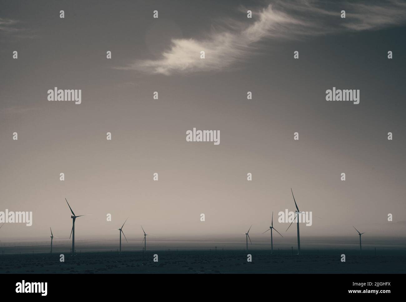 A wind turbines under a cloudy dark sky Stock Photo - Alamy