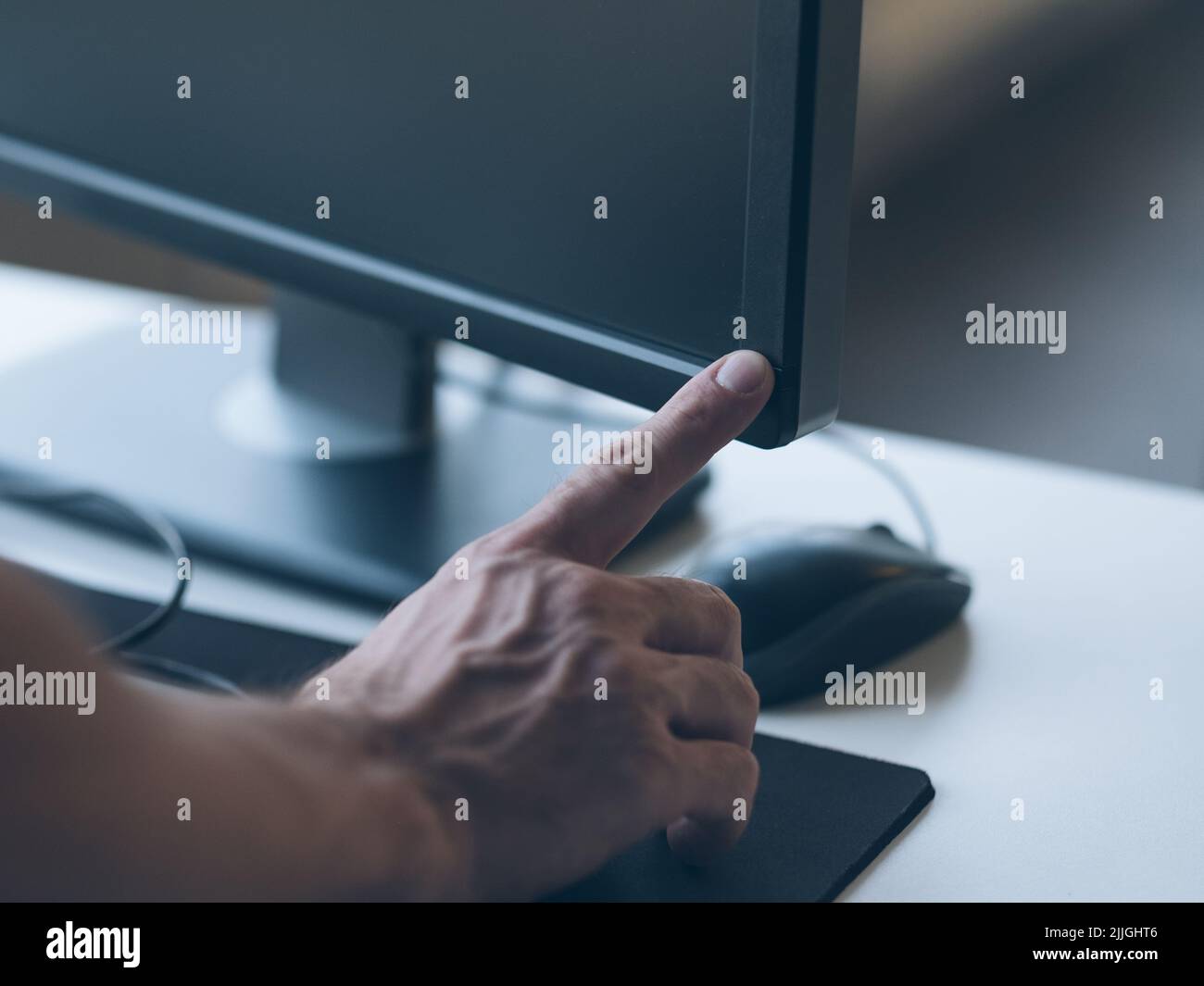 office worker routine man switching monitor on Stock Photo - Alamy