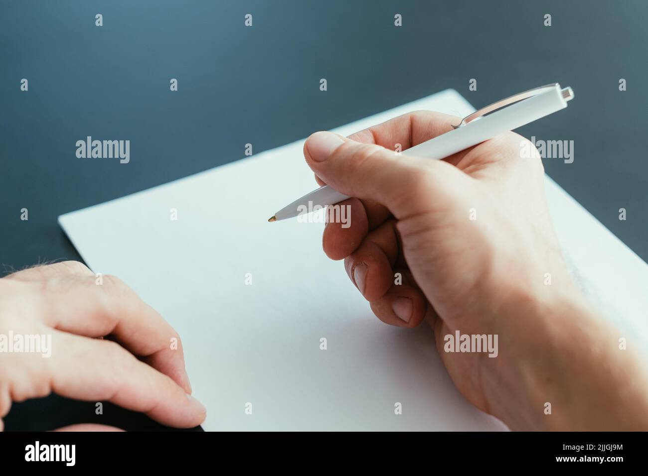 Man holding white paper pen hi-res stock photography and images - Alamy