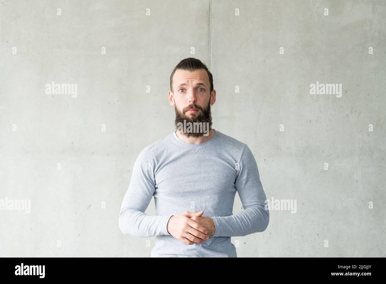 empathy compassion bearded hipster guy gray wall Stock Photo - Alamy