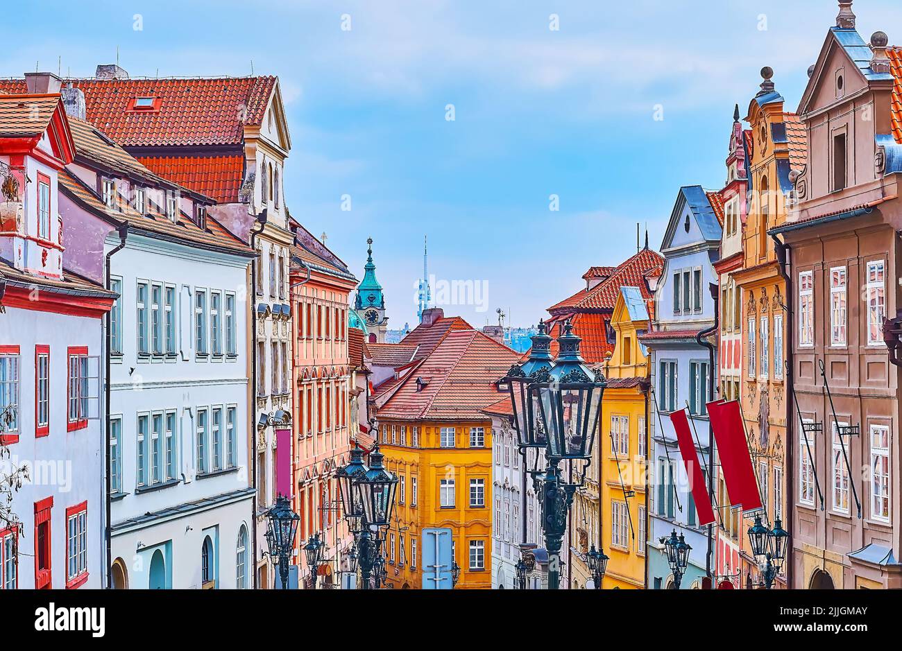 The scenic colored houses' facades with moulding, sculptures, relief ...