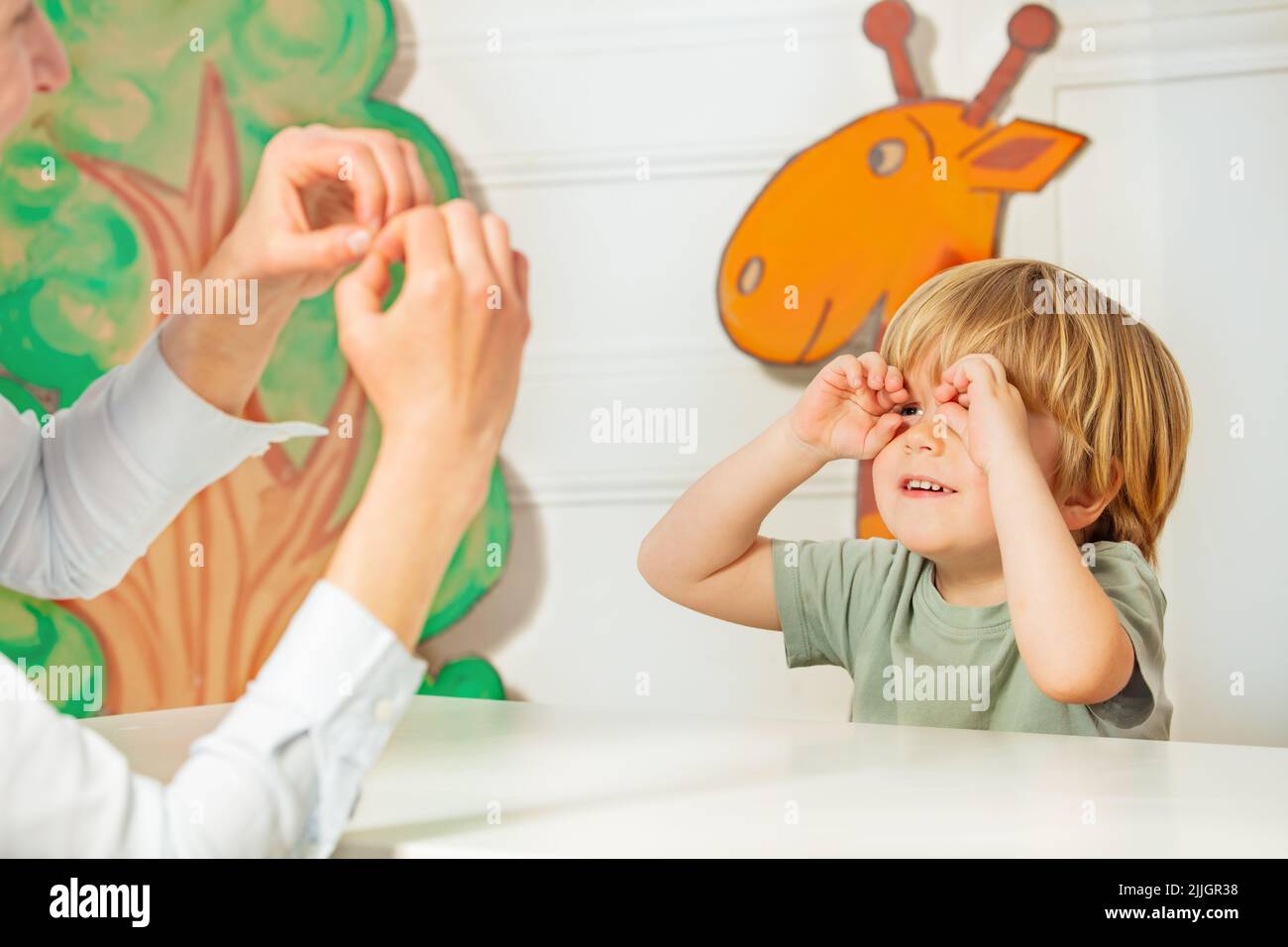 Little blond boy copy pilot mask finger gesture in class Stock Photo ...
