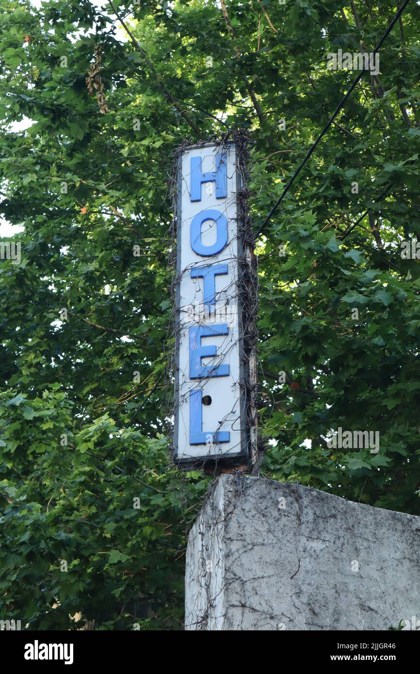 The vertical view of a blue hotel sign on the wall outdoors Stock Photo ...