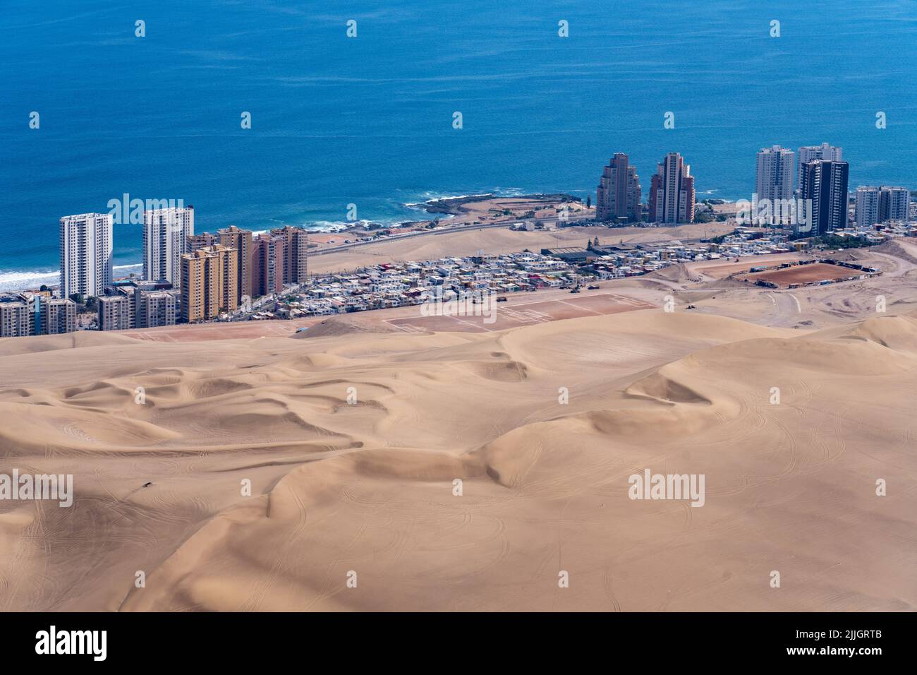 The giant sand dunes of Cerro Dragon with the city of Iquique, Chile ...