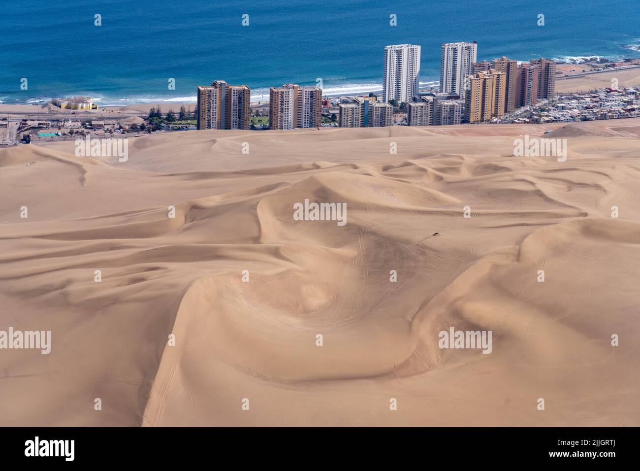 The giant sand dunes of Cerro Dragon with the city of Iquique, Chile ...