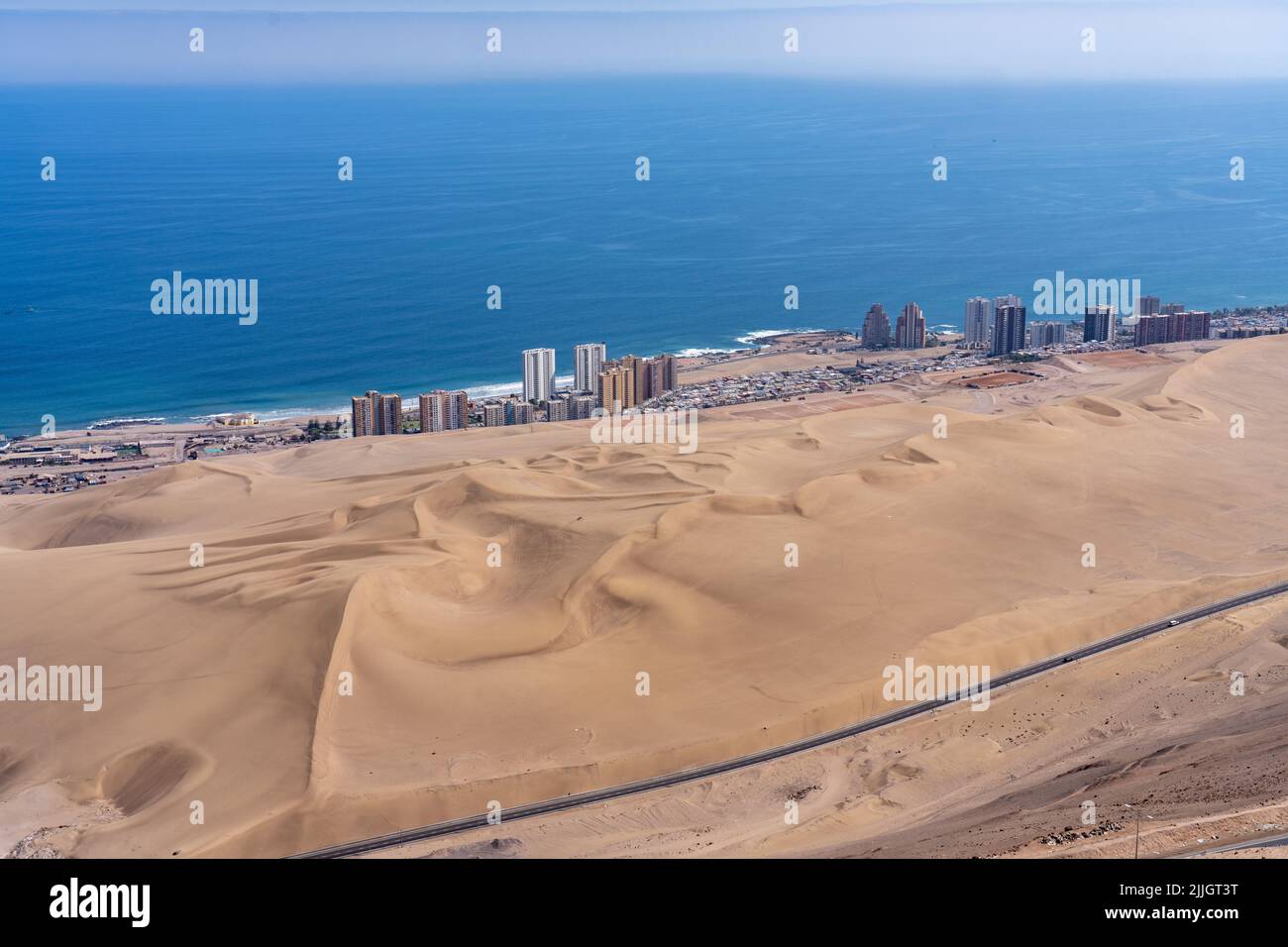 The giant sand dunes of Cerro Dragon with the city of Iquique, Chile ...