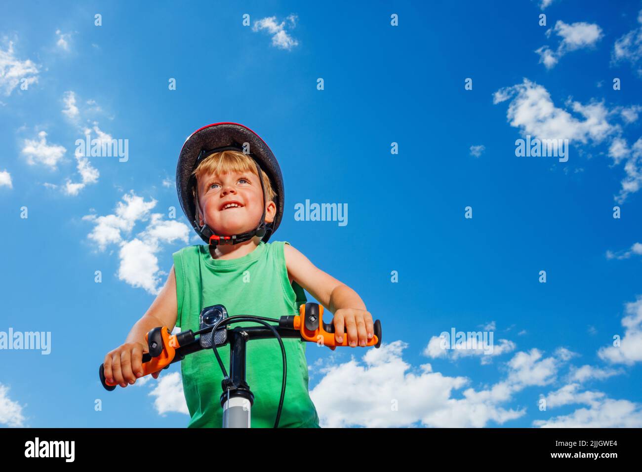 Low angle portrait of a little smiling boy ride small bicycle Stock ...