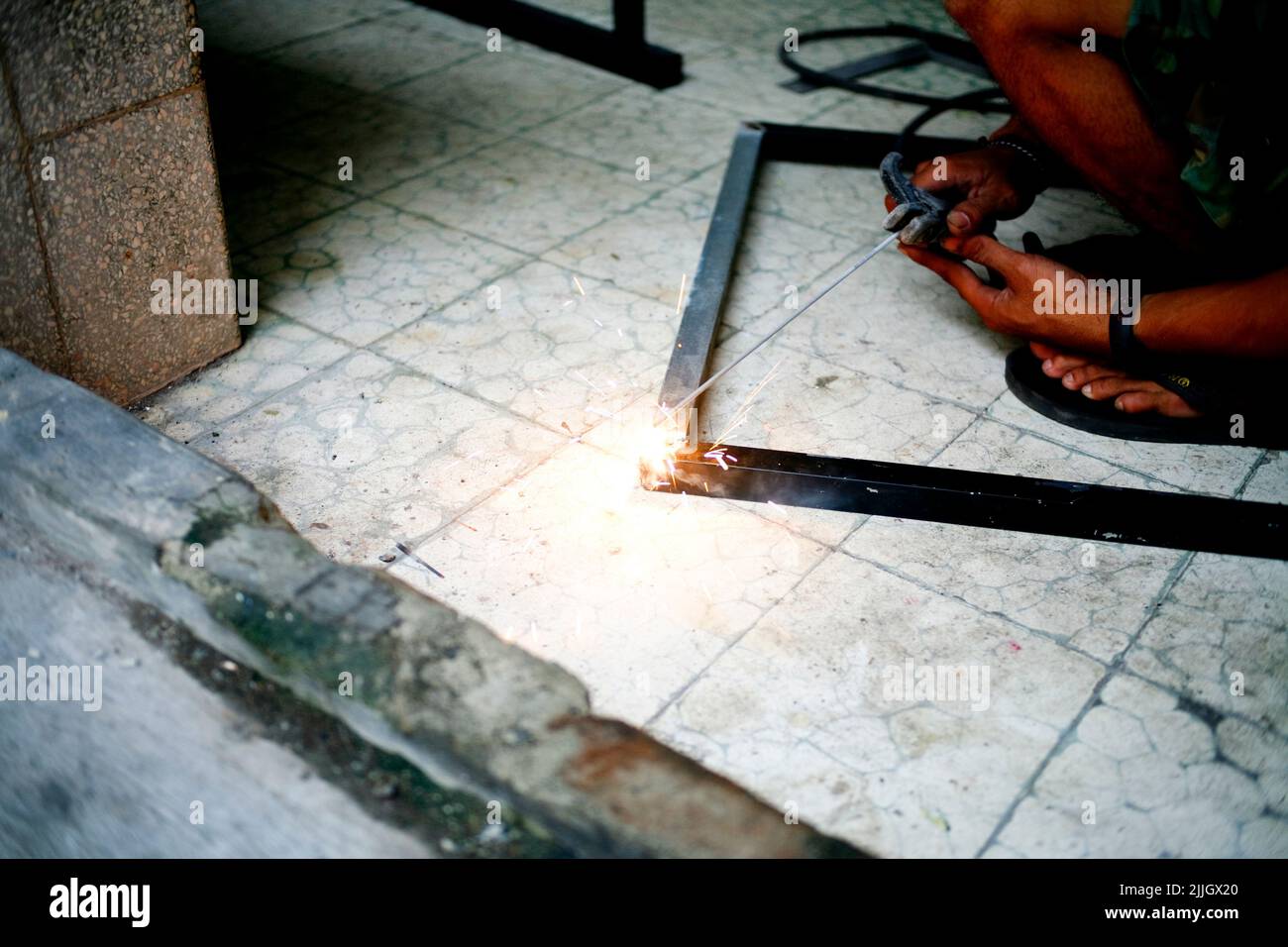 Asian traditional industry worker welding the iron pieces at work Stock ...