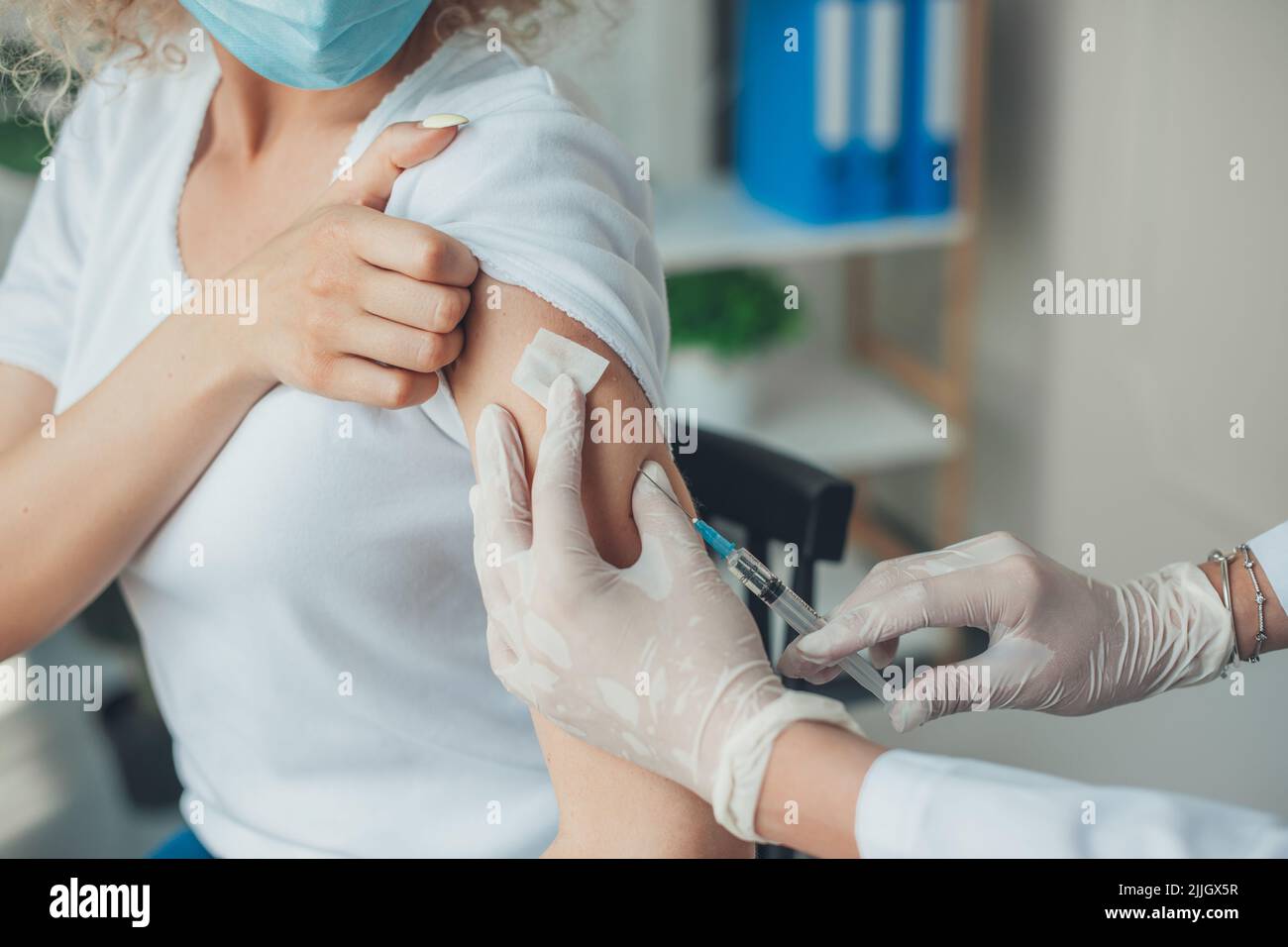 Doctor in medical gloves giving antivirus vaccine shot to a patient ...
